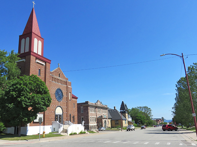 The red-topped church in Munising stands like a friendly sentinel, watching over the quiet main street where time seems to stand still.