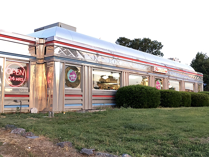 This gleaming silver diner car looks like it rolled straight out of a 1950s movie set. 