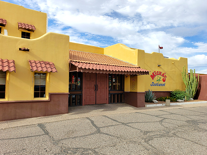 The sunshine-yellow exterior of Micha's stands like a beacon of culinary promise against the Tucson sky, its terracotta roof tiles adding that perfect southwestern touch.
