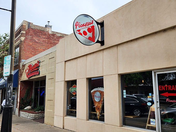 Picasso's Pizzeria beckons with its artistic flair! That slice-shaped sign promises a masterpiece of flavor waiting just beyond those doors.