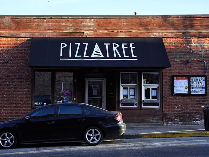 That brick exterior whispers secrets while the neon sign shouts "pizza paradise awaits inside!"