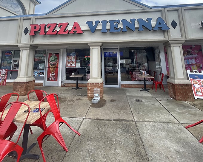 Pizza Vienna's storefront welcomes you with those cherry-red chairs &ndash; like little flags signaling "great pizza ahead!"