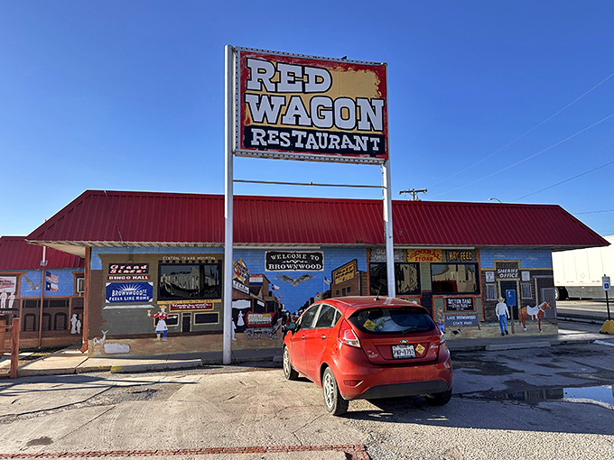 The Red Wagon Restaurant's iconic sign stands tall against the Texas sky, promising comfort food that'll make your heart sing.