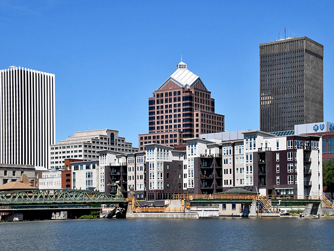 Rochester's downtown skyline reflects perfectly in the Genesee River, like a postcard that forgot to charge extra.