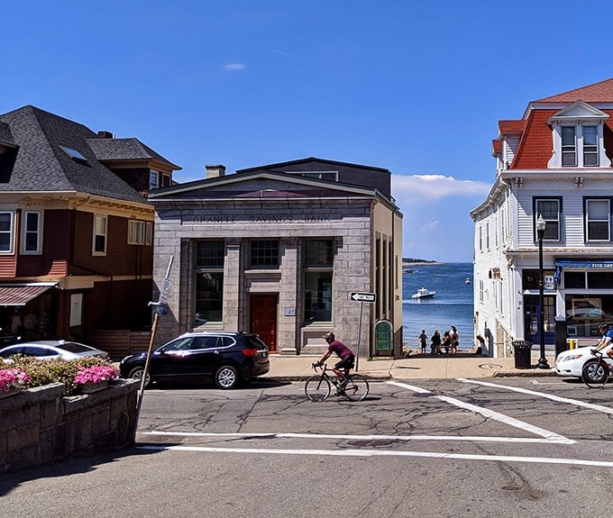 Rockport's downtown meets the sea in perfect harmony. That stone bank building stands like a sentinel guarding the path to ocean views beyond.