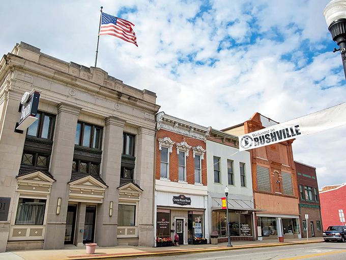Main Street magic! Rushville's historic facades stand proud under Old Glory, where small-town charm meets Americana in every weathered brick and welcoming banner.