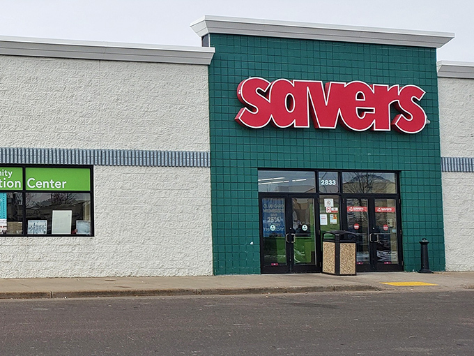 The iconic red Savers sign beckons bargain hunters like a retail lighthouse in a sea of full-price stores.