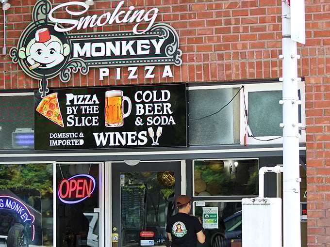 That cheerful monkey knows something you don't &ndash; the best pizza secrets hide behind brick walls.