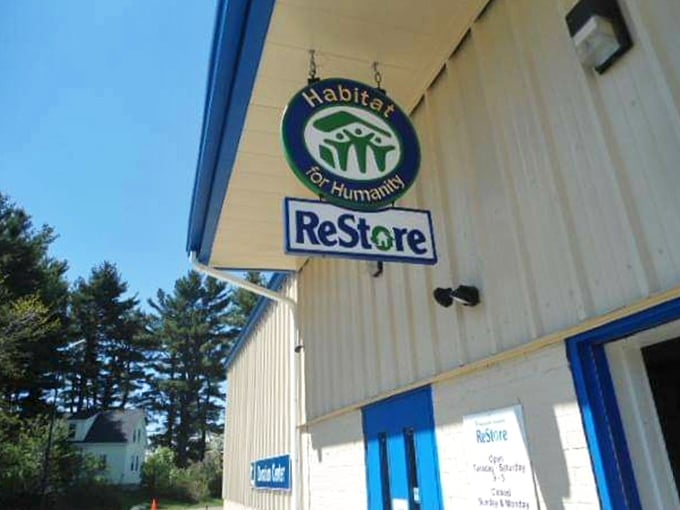 The iconic blue and green Habitat ReStore sign beckons with the promise of home treasures and good karma.