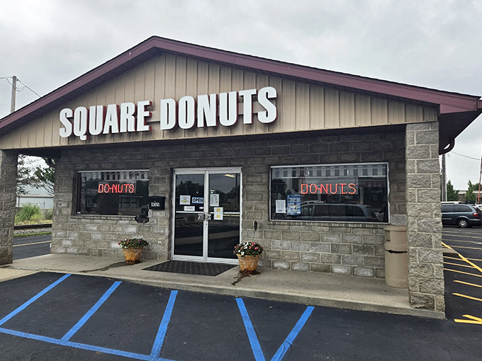 Square Donuts' stone building stands like a temple to unconventional pastries. The neon signs promise a sweet rebellion against circular conformity.