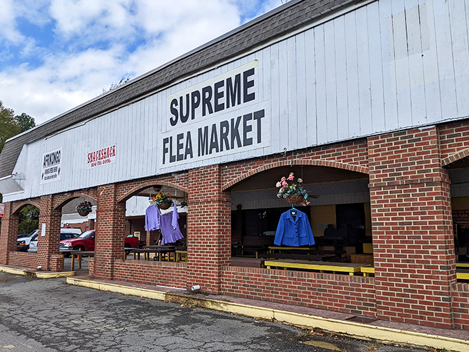That brick facade with "Supreme Flea Market" boldly displayed promises treasures waiting inside for savvy shoppers.