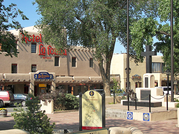 Historic Hotel La Fonda stands proudly in Taos Plaza, where adobe dreams and mountain views create the perfect New Mexico postcard.