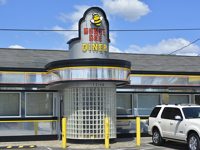 The gleaming chrome and glass block entrance of Honey Bee Diner stands as a beacon of breakfast hope on Ritchie Highway.