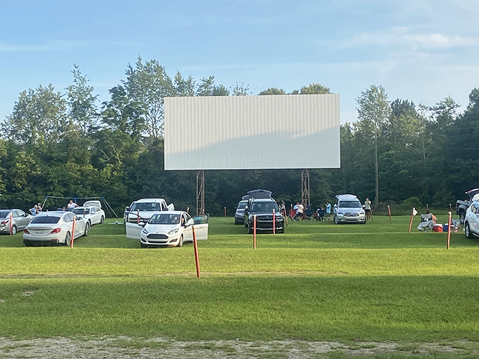 Cars lined up like eager moviegoers at a premiere, the massive white screen waiting patiently for dusk to transform it into a portal to another world.