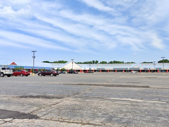 The Outlet Shoppes at Oshkosh stretches out like a bargain hunter's dream under Wisconsin's big blue sky. Those distinctive blue roofs are practically calling your name!