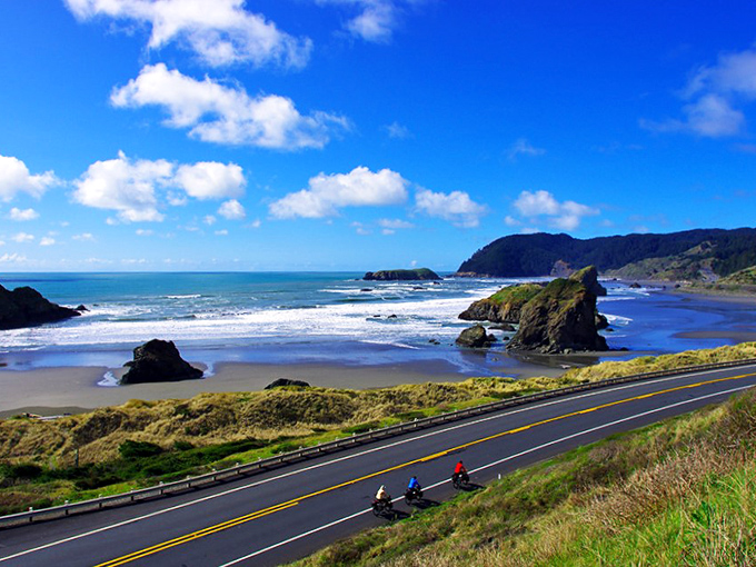 Nature's perfect highway unfolds where asphalt meets ocean spray. Cyclists experience the Oregon Coast in its purest form, with sea stacks standing sentinel.