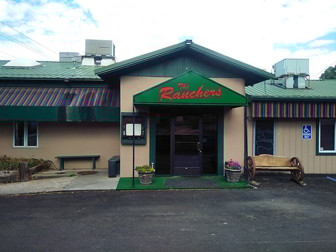 That welcoming green awning beckons like a lighthouse for hungry mountain travelers seeking serious steak satisfaction.
