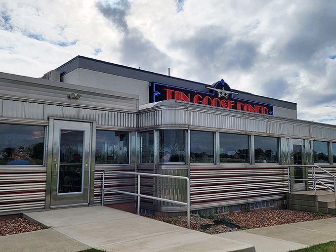 The Tin Goose Diner's gleaming exterior shines like a silver beacon of comfort food, promising nostalgic delights inside.