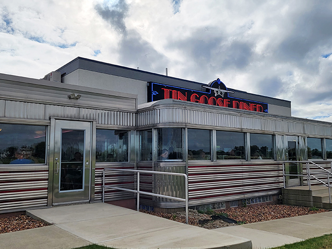 The gleaming silver exterior of Tin Goose Diner beckons like a time machine disguised as a restaurant.