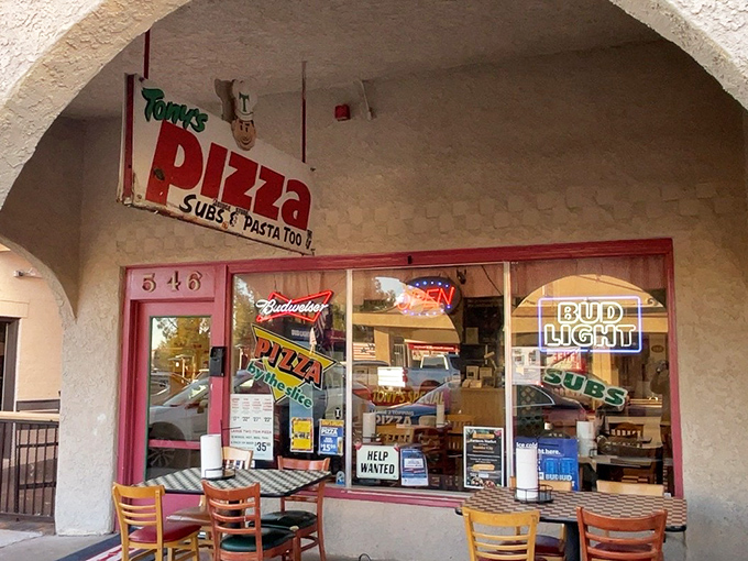 The classic red storefront beckons like an old friend promising comfort in every slice.