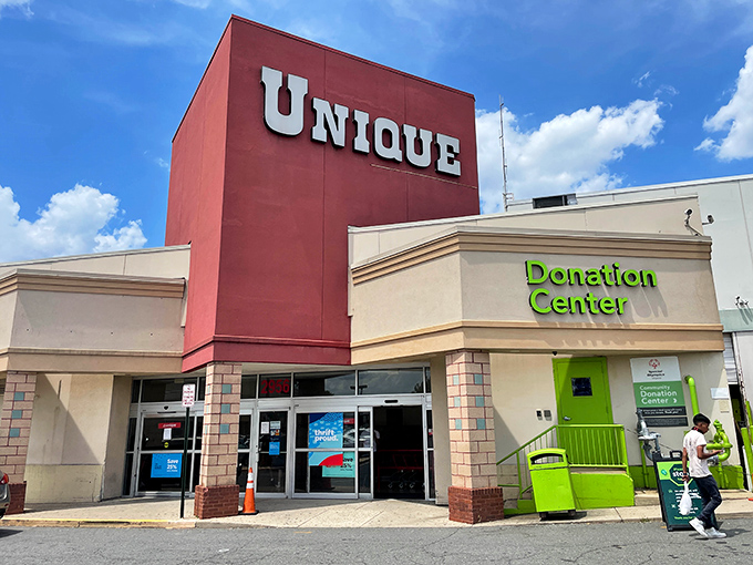 The bright red "UNIQUE" sign beckons like a lighthouse for bargain hunters. This thrift wonderland promises treasures behind those unassuming doors.