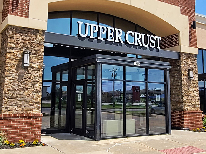 Upper Crust's welcoming entrance promises wood-fired delights within. That stone and brick exterior isn't just for show&mdash;it's a hint of the warmth waiting inside.