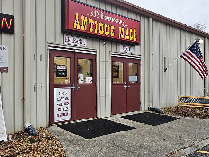 The entrance to Williamsburg Antique Mall beckons with vintage charm and an American flag proudly waving hello to treasure hunters.