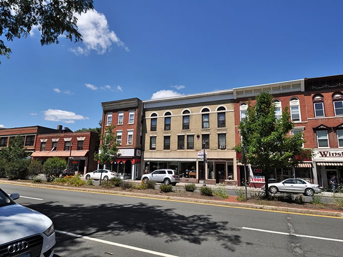 Historic brick buildings line Winsted's Main Street, offering small-town charm with big personality. New England character without the coastal price tag!