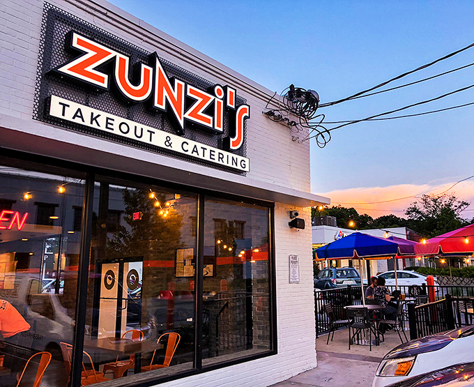 Zunzi's glowing sign beckons sandwich lovers like a lighthouse for the hungry. The outdoor patio promises a perfect spot for people-watching while you devour their famous Conquistador.