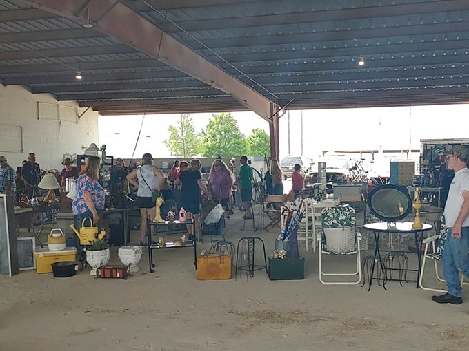 The thrill of the hunt! Bargain-seekers swarm like happy bees through this concrete jungle of chairs, mirrors, and forgotten treasures under industrial rafters.