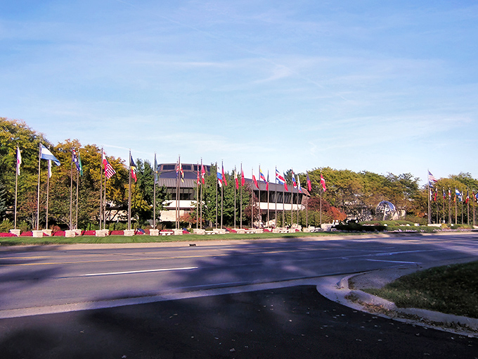International flags line the entrance to Ada Township, welcoming visitors with a global hello that doesn't require a passport&mdash;or a fat wallet.