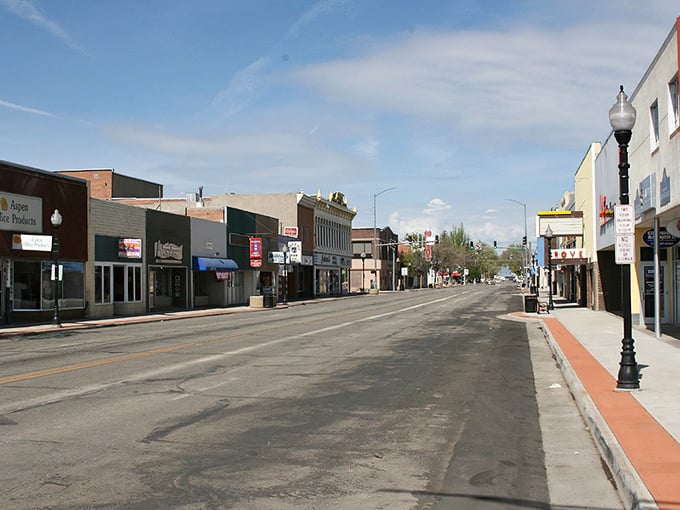 Classic storefronts line the street where neighbors still wave hello and coffee conversations last all morning long.
