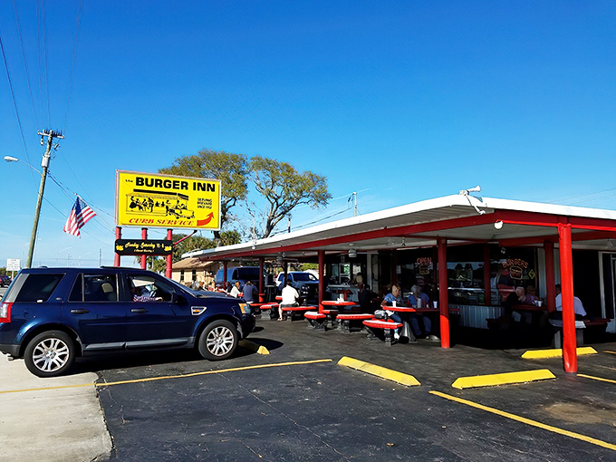 Red and white awnings welcome hungry visitors to a slice of American nostalgia. This drive-in knows burgers aren't meant to be complicated.