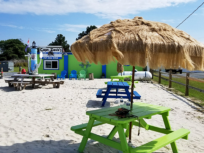 Beach vibes and seafood dreams! Captain Zack's colorful picnic tables and thatched umbrella set the perfect stage for coastal feasting.