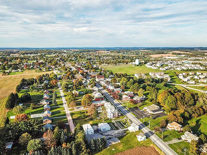 Bird's eye view of Clearfield reveals a patchwork of affordable homes nestled among trees, where your retirement dollars stretch like summer evenings.