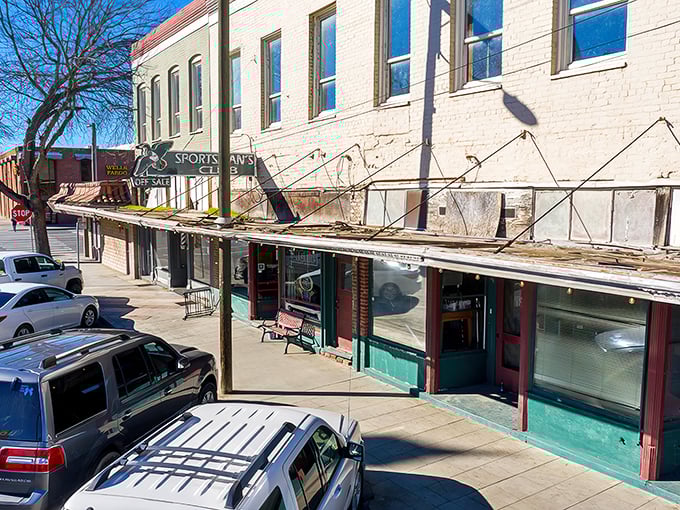 Under fading awnings, the Sportsman's Club beckons with small-town promises. Wells Fargo might hold your money, but Colusa holds affordable dreams.