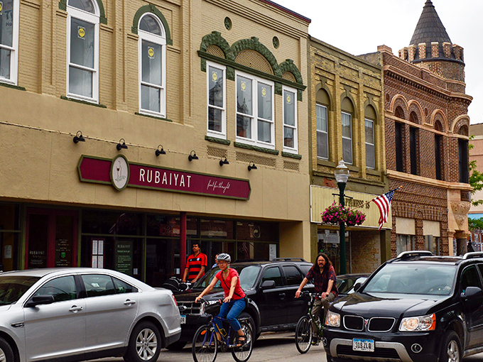 Cyclists enjoy Decorah's bike-friendly streets, passing the Rubaiyat restaurant housed in a classic brick building with European charm.