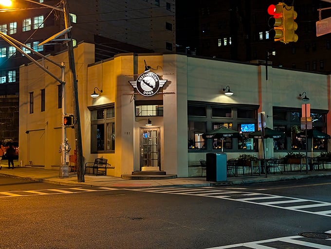 Evening lights illuminate a neighborhood favorite that's redefining the humble hot dog experience.