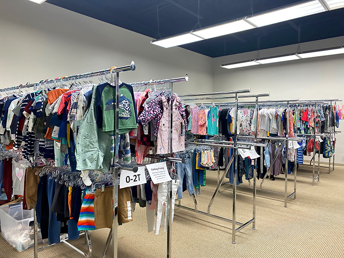 Racks upon racks of neatly organized children's clothing await new homes. Marie Kondo would approve of this tidy bargain paradise.