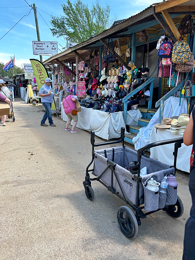 Shopping carts and strollers navigate the pathways between vendor stalls. Grammy's Shoes and Doll Boutique offers a glimpse into vintage charm!