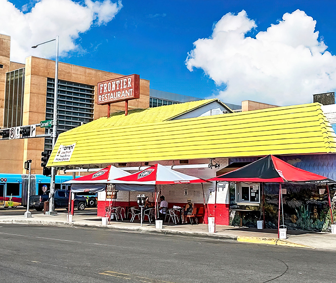Frontier's yellow awning and outdoor seating area&mdash;where green chile dreams and college memories are made in equal measure.