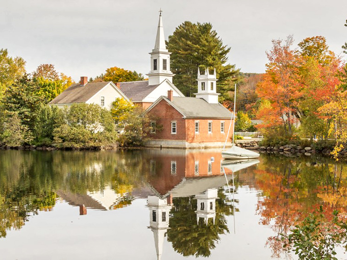 That white-steepled church reflected in the calm waters and framed by autumn trees? It&rsquo;s pure Norman Rockwell brought to life.