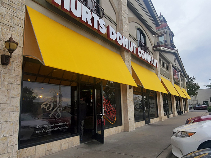 The stone facade might say "upscale," but those yellow awnings scream "get in here and treat yourself to something ridiculous!"