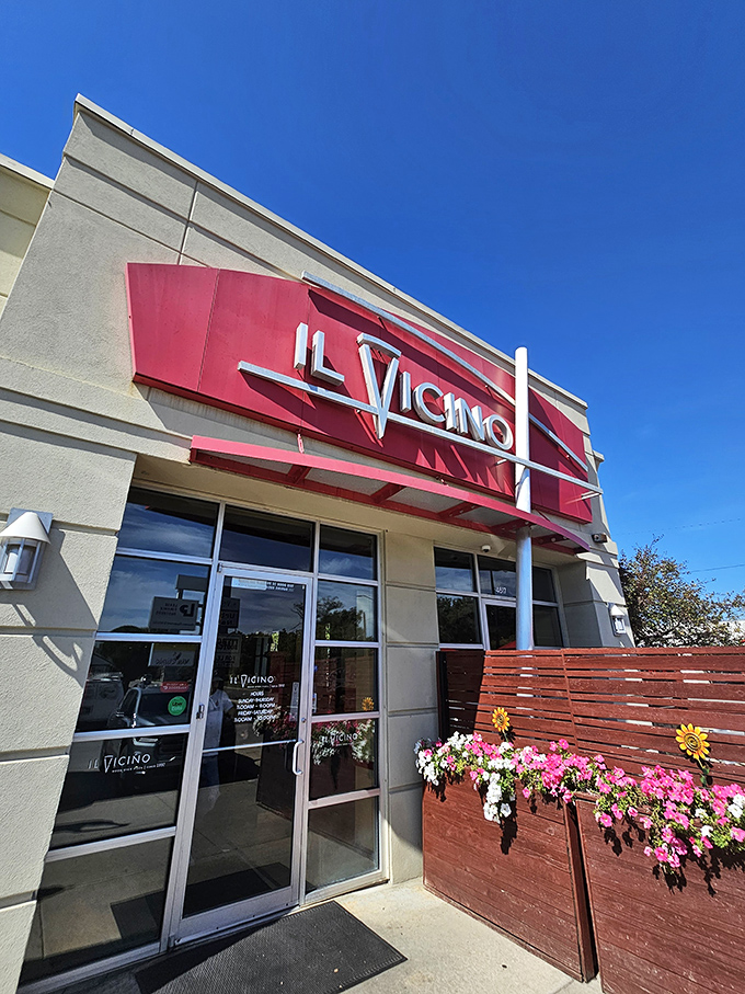 The welcoming entrance of Il Vicino, where flowers bloom and pizza dreams come true. Carb paradise awaits!