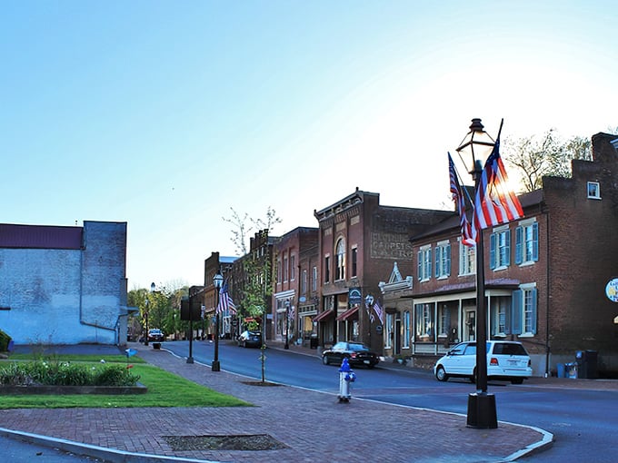 A postcard-perfect scene of small-town America, where brick storefronts welcome visitors and every lamppost seems to have a story to tell.