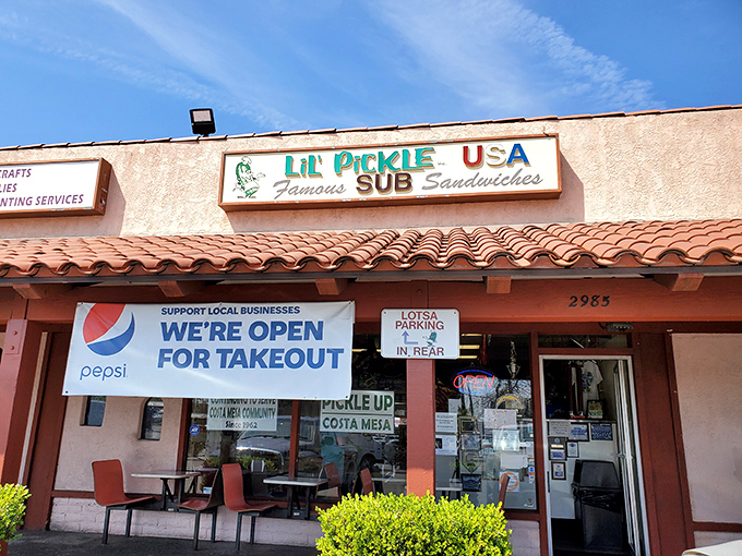That cheerful green sign promises pickle-perfect sandwiches that'll make your taste buds dance.