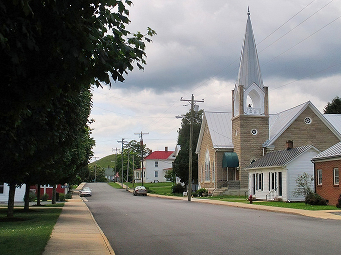 That church steeple points heavenward while the town below keeps both feet firmly planted in simpler times.