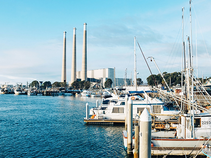 Those iconic smokestacks frame a postcard-perfect marina where fishing boats outnumber yacht clubs.