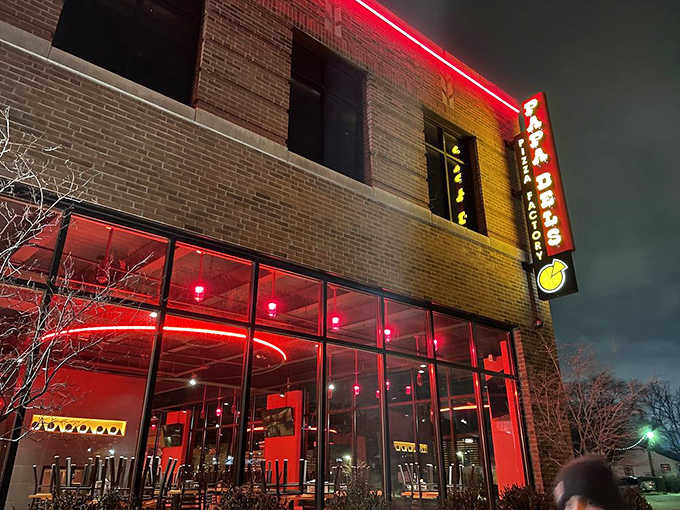 At night, Papa Del's glows with red neon warmth &ndash; like a lighthouse guiding hungry souls to pizza paradise.