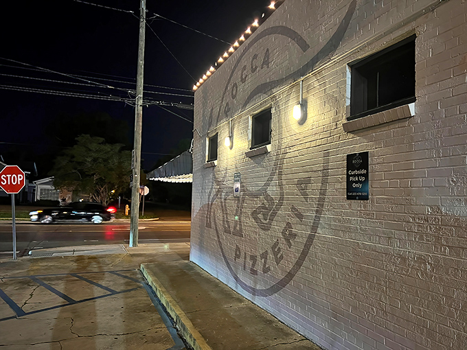 Nighttime transforms Rocca into a glowing pizza sanctuary. Those string lights aren't just for show&mdash;they're beacons guiding hungry souls home.